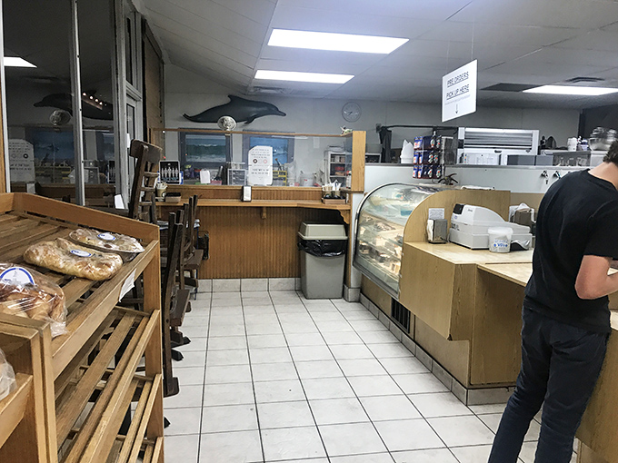 No-frills interior with wooden shelves and simple display cases – because when your donuts are this good, you don't need fancy décor to impress.
