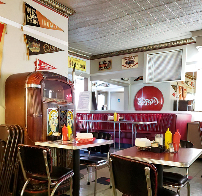 Step inside and the decades melt away. Vintage pennants, red vinyl booths, and a jukebox create an atmosphere where Elvis might walk in any minute to order a milkshake.