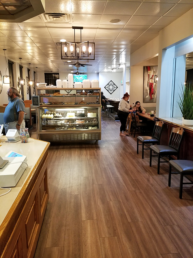 Step inside to find warm wood tones, modern lighting, and that glass-enclosed temple of temptation—the bakery case that stops first-timers in their tracks.