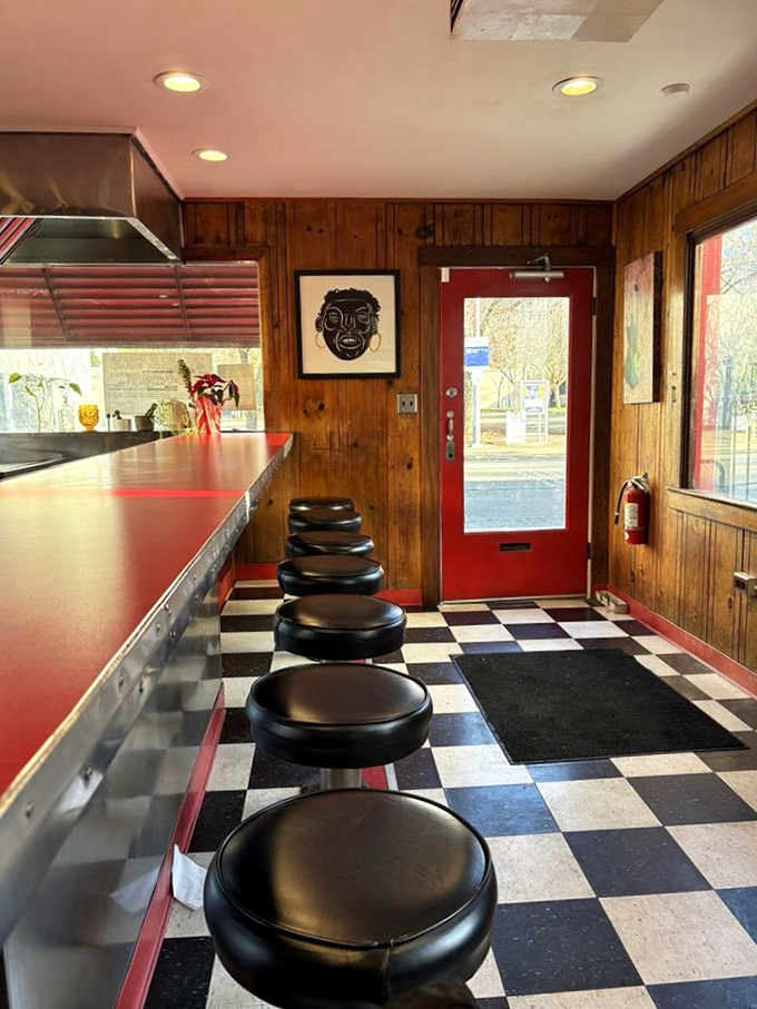 Counter seating that invites you to pull up a stool and watch the magic happen. That classic checkered floor isn't just decoration—it's a portal to simpler times.