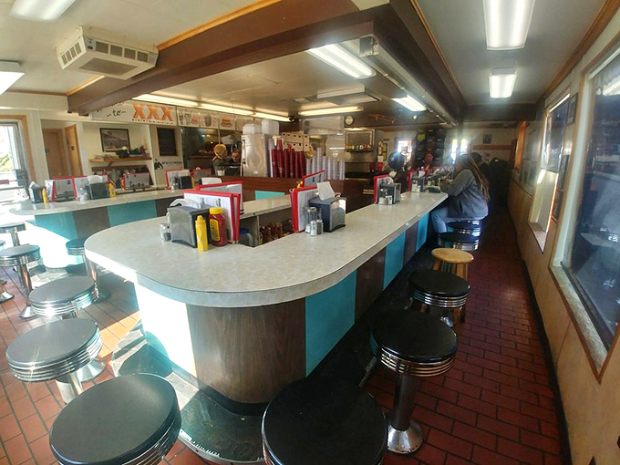 The horseshoe counter isn't just nostalgic design—it's where strangers become friends over coffee and where breakfast dreams come true at any hour.