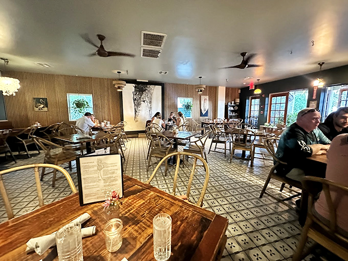 Inside, wood-slat walls and patterned tile floors create a space that feels both modern and timeless—like your coolest friend's dining room.
