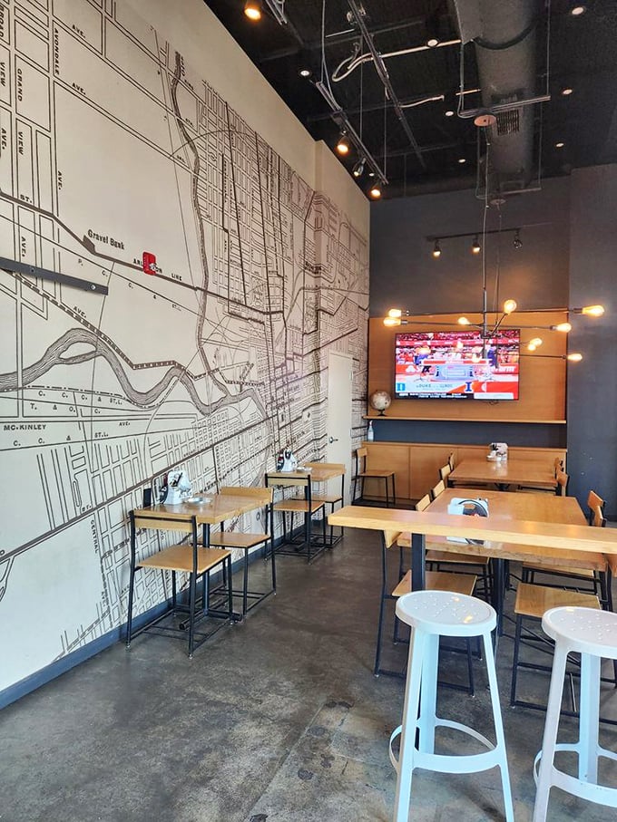 The wall-sized map isn't just decor—it's your invitation to explore Columbus after you've conquered your burger. Industrial-chic meets neighborhood warmth. 