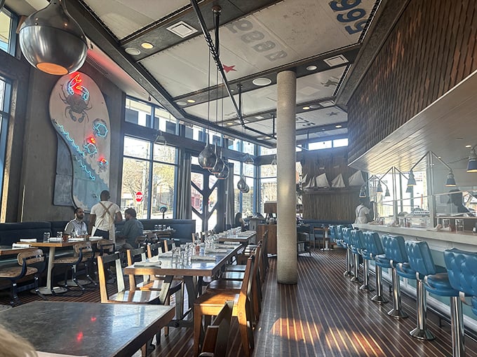 The interior blends shipshape elegance with casual comfort—wooden accents and blue chairs creating an atmosphere that says "serious seafood, zero pretension."