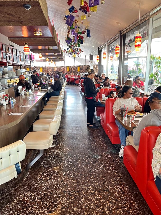 Red vinyl booths, terrazzo floors, and pendant lamps create the perfect diner symphony. This isn't retro-inspired; it's authentically retro.