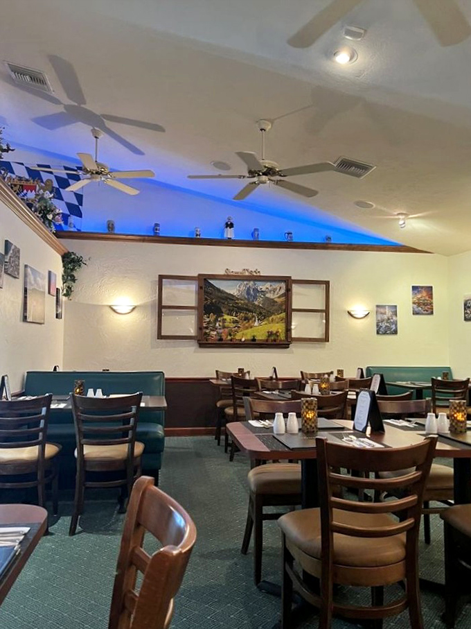 Blue ambient lighting and Bavarian décor transform this dining room into a slice of Munich. The ceiling fans are Florida's gentle reminder you're still in paradise.