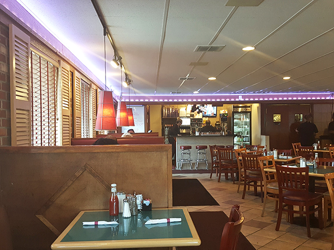 Purple neon lights and cozy wooden booths create the perfect backdrop for conversations that flow as freely as the coffee refills.