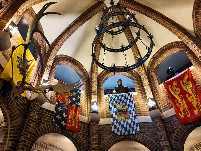 Medieval meets magnificent under these brick arches. The great hall's soaring ceiling, colorful heraldic banners, and wrought-iron chandelier transport visitors across centuries and continents. 