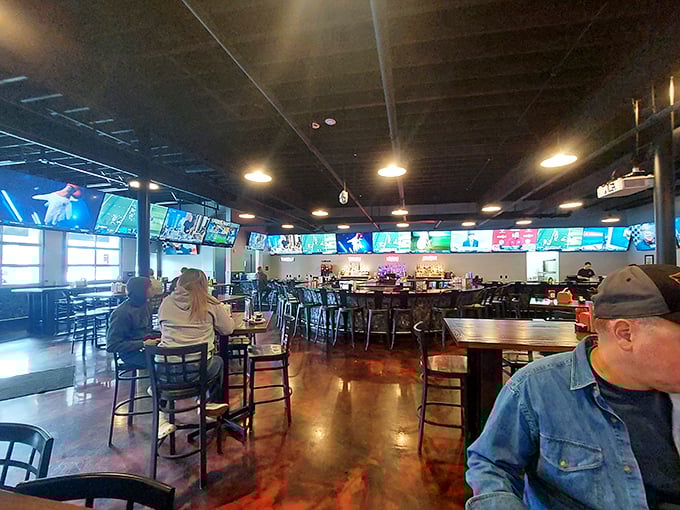 TVs as far as the eye can see. This isn't just a sports bar—it's a cathedral where the religion is good food and live games.