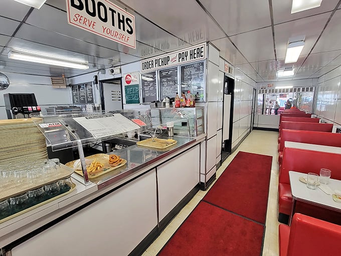Classic diner perfection: gleaming white tiles, red vinyl booths, and a counter that's witnessed decades of Troy's morning conversations and lunchtime revelations.