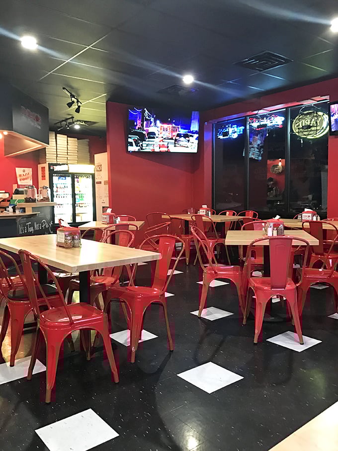 Inside, those cherry-red chairs aren't just seating—they're front-row tickets to Pennsylvania's most passionate pizza performance.
