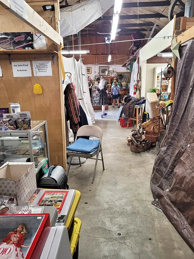 Narrow pathways lead to unexpected discoveries as shoppers navigate the indoor labyrinth. That folding chair isn't for sitting—it's for when you need a moment to contemplate your next vintage acquisition. 