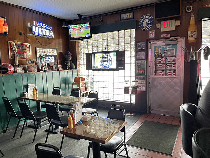 Inside, wood paneling and glass block windows create a time capsule of tavern authenticity where conversations flow as freely as the beer.