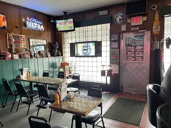 Inside, wood paneling and glass block windows create a time capsule of tavern authenticity where conversations flow as freely as the beer.