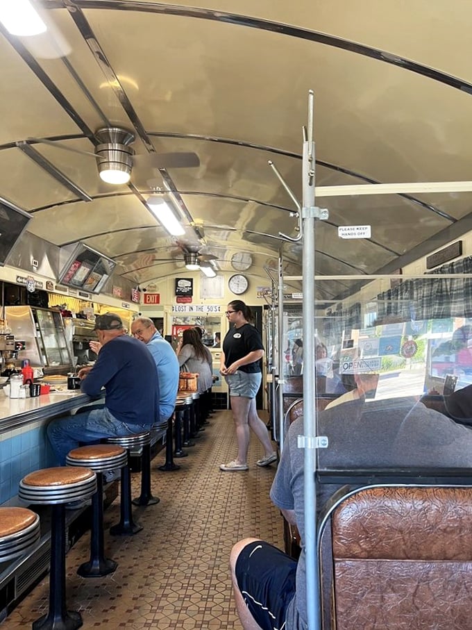 Inside this narrow railcar-turned-restaurant, the curved ceiling and counter seating create the quintessential diner experience where conversations flow as freely as the coffee.