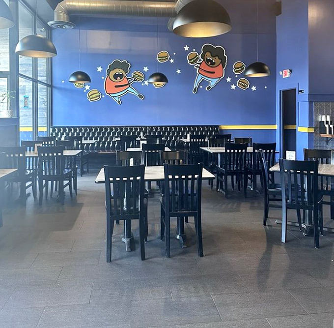 The playful blue walls adorned with burger-wielding cartoon characters set the perfect tone: serious about food, not so serious about everything else.