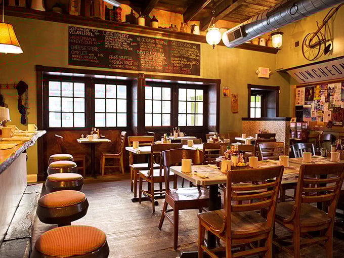 Wooden tables, exposed brick, and natural light create the perfect backdrop for morning conversations that flow as freely as the coffee refills.