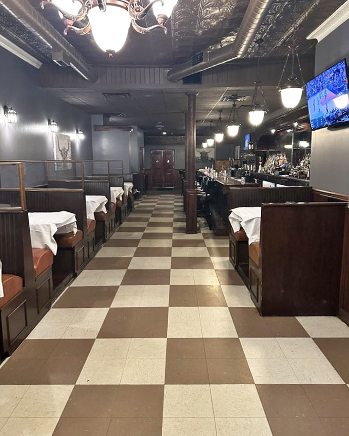 Classic checkered floors and wooden booths create that perfect old-school steakhouse vibe – where memories are made between bites of perfectly aged beef.