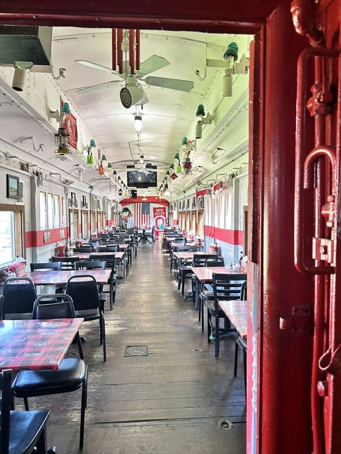 Step inside and you're transported to a bygone era, where the narrow dining car's red and white interior captures the romance of rail travel with modern comfort.