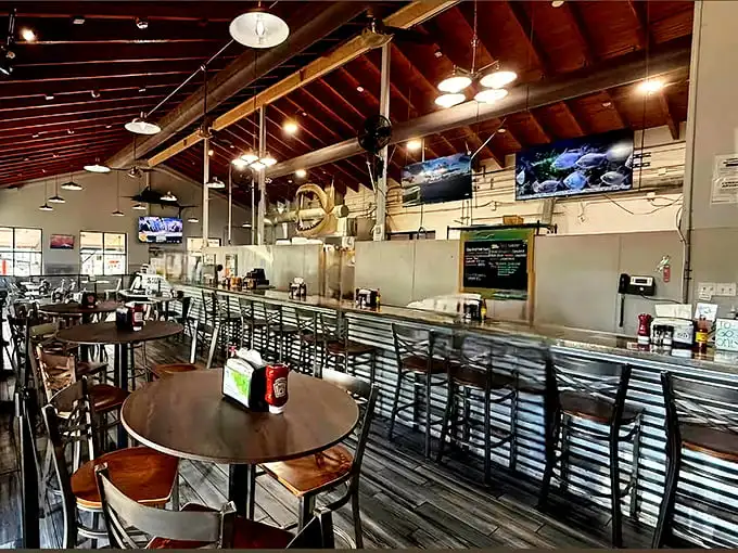 Exposed wooden beams and casual seating create that perfect "I've discovered something authentic" vibe. The kind of place where calories don't count because you're on vacation.