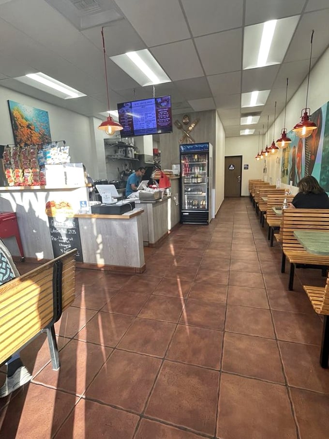 Simple wooden benches and coastal artwork create an unpretentious backdrop where the real stars—those magnificent lobster rolls—can shine without distraction.