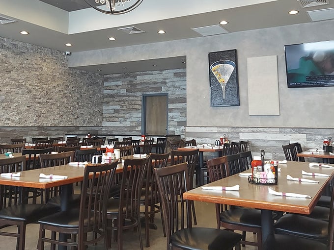 Modern meets classic in this thoughtfully renovated dining room. The stone accent walls and warm lighting create an atmosphere that says "stay awhile."