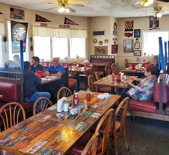 Step inside and you've entered the breakfast equivalent of Cheers—where red vinyl booths and sports pennants create the perfect backdrop for morning conversations.