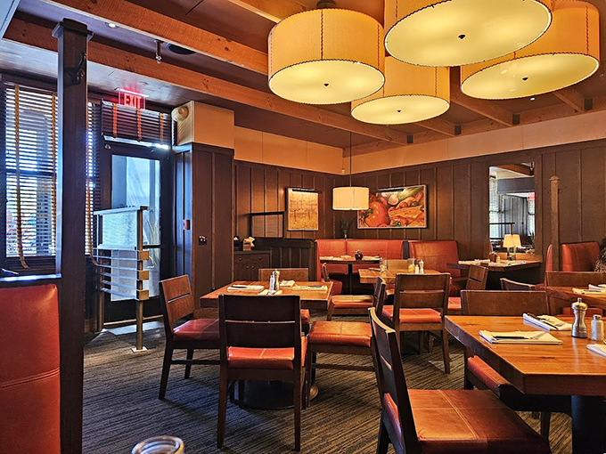 Warm wood tones and drum pendant lighting create the perfect backdrop for both business lunches and anniversary dinners. Ambiance that whispers "special" without shouting "pretentious."