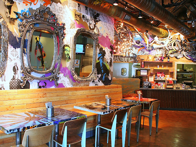 Where art gallery meets eatery – vintage mirrors against graffiti-splashed walls create a dining space that feeds your eyes before the food arrives.