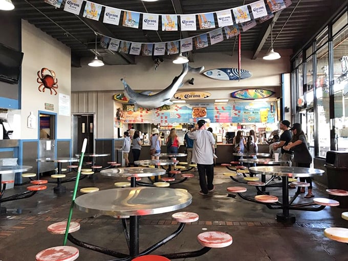 Colorful Corona banners and hanging fish set the festive mood. This isn't fine dining—it's fun dining, where memories are made between bites.