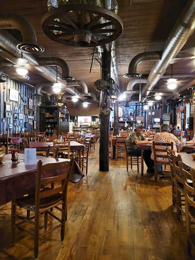 Wagon wheels overhead, wooden beams everywhere, and the promise of sizzling perfection. This isn't decor; it's a Tennessee love letter to carnivores.
