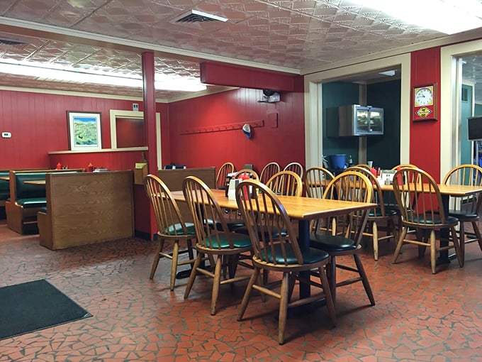 Red walls, wooden chairs, and that classic pressed tin ceiling—this isn't interior design, it's barbecue authenticity that's been perfected over decades.