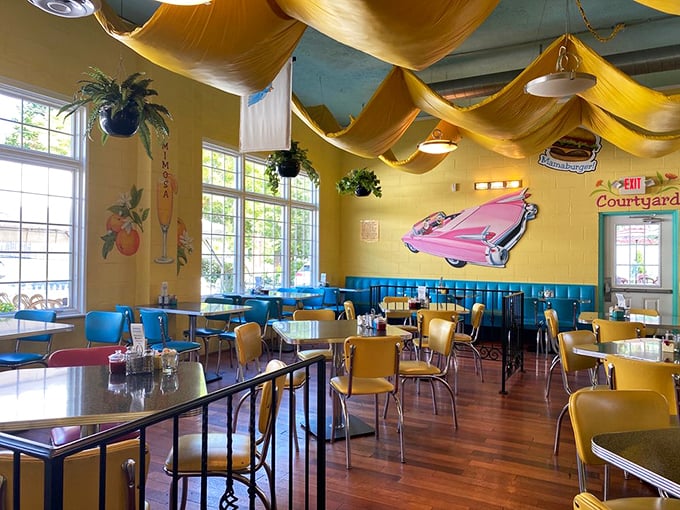 Fabric draped from the ceiling creates a whimsical canopy effect, while the pink Cadillac on the wall reminds you this breakfast paradise has automotive roots. Photo
