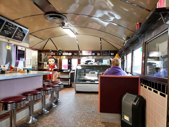 Step inside and time stands still—red vinyl stools, curved ceiling, and the promise of comfort food that makes Monday mornings bearable.