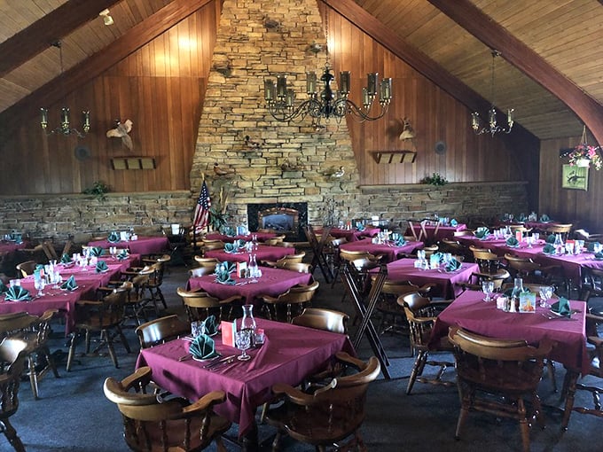 Cathedral ceilings, stone fireplace, burgundy tablecloths – this isn't just dining, it's a Midwestern sanctuary where memories are made between courses.