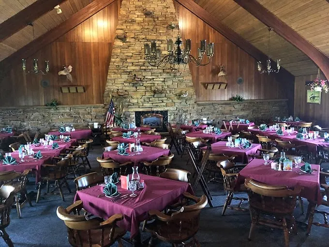 Cathedral ceilings, stone fireplace, burgundy tablecloths – this isn't just dining, it's a Midwestern sanctuary where memories are made between courses.