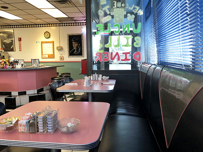 Classic diner aesthetics at their finest—pink tables, vinyl booths, and the promise of a meal that won't require a second mortgage.