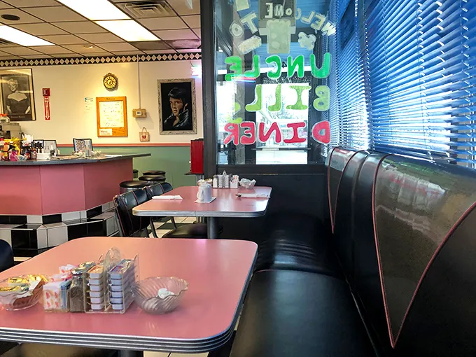 Classic diner aesthetics at their finest—pink tables, vinyl booths, and the promise of a meal that won't require a second mortgage.