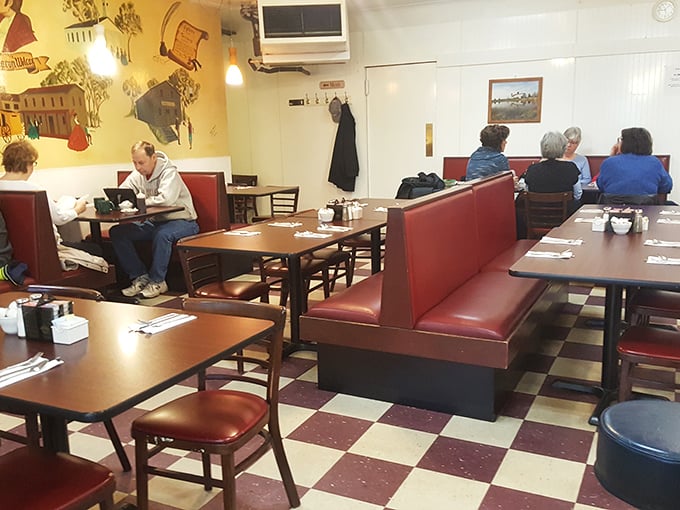 Classic red vinyl booths and checkerboard floors set the stage for breakfast theater where every plate gets a standing ovation.