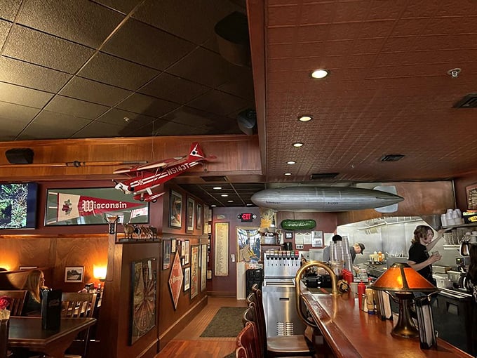 Model airplanes and zeppelins hover above diners like culinary guardian angels. This isn't just decor—it's a promise that your taste buds are about to take flight.