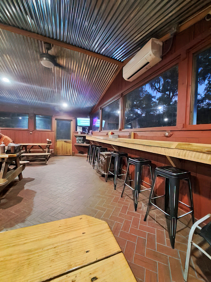 The corrugated metal ceiling and wooden bar stools aren't trying to impress anyone—they're just setting the stage for the real star: what's coming out of the kitchen.