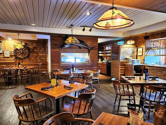 Wooden paneling, nautical decor, and stained glass lighting create the perfect maritime hideaway. This dining room feels like the captain's quarters of a beloved sailing vessel.
