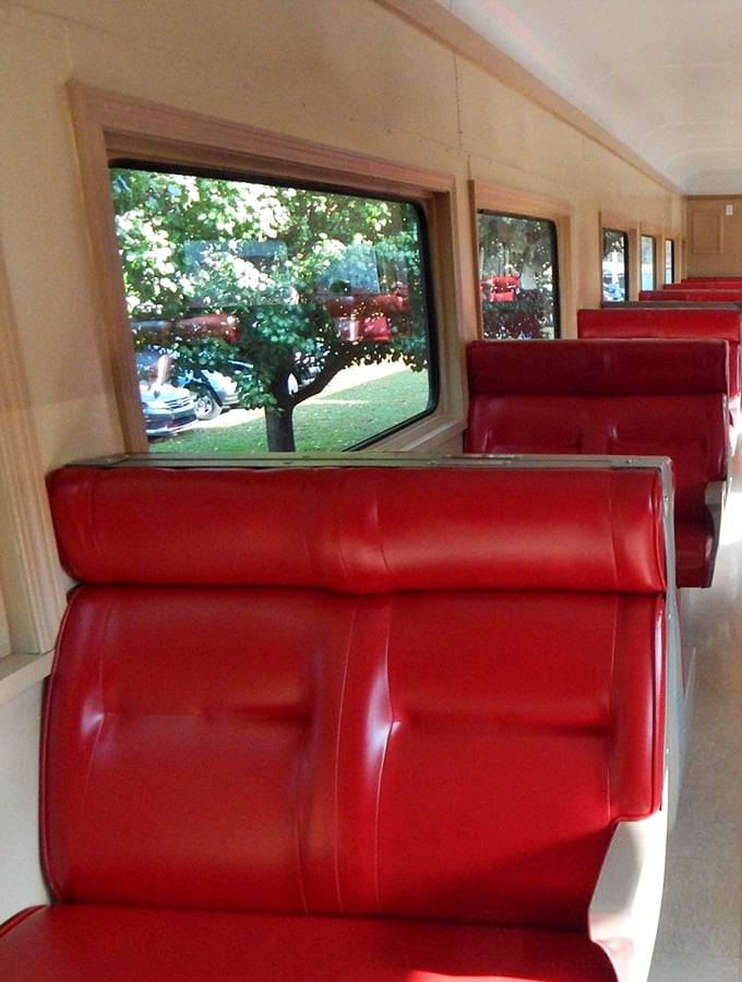 Those cherry-red seats aren't just comfortable—they're time machines to an era when travel was an event, not just transportation.