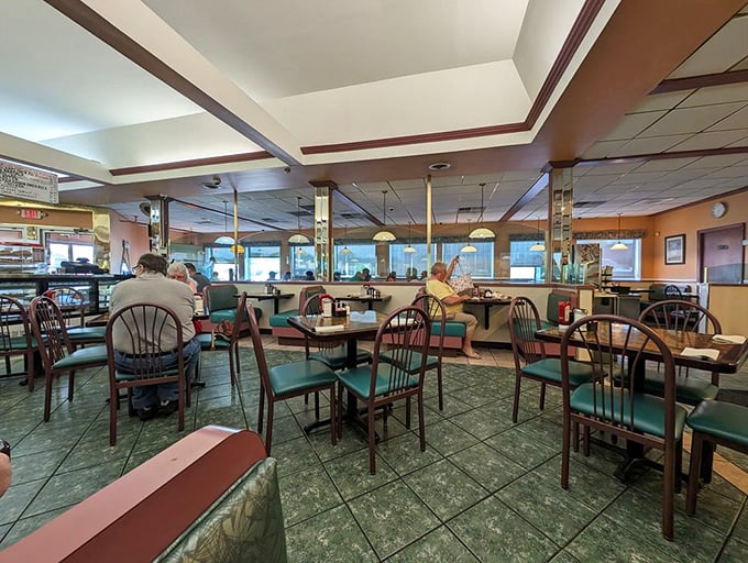 Inside, teal chairs and mirrored columns create that perfect diner atmosphere—where conversations flow as freely as the coffee refills.