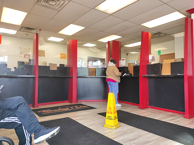 Step inside where red columns frame your path to fried chicken paradise, no reservations required.
