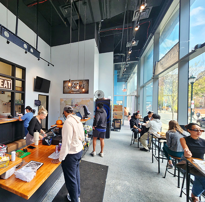 The modern industrial design creates an unexpectedly sophisticated atmosphere where culinary magic happens in plain sight.