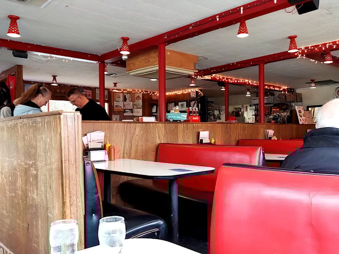 Inside, cherry-red vinyl booths and wood paneling create that perfect nostalgic atmosphere where calories don't count and conversations flow as freely as the coffee.