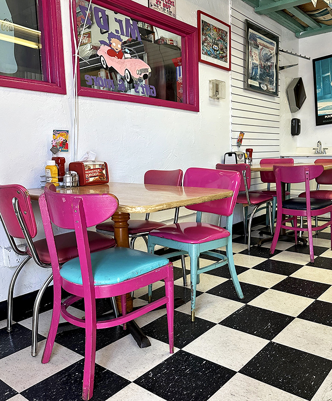 Hot pink chairs against checkerboard floors—this isn't just interior design, it's a mood-altering experience that comes with fries.