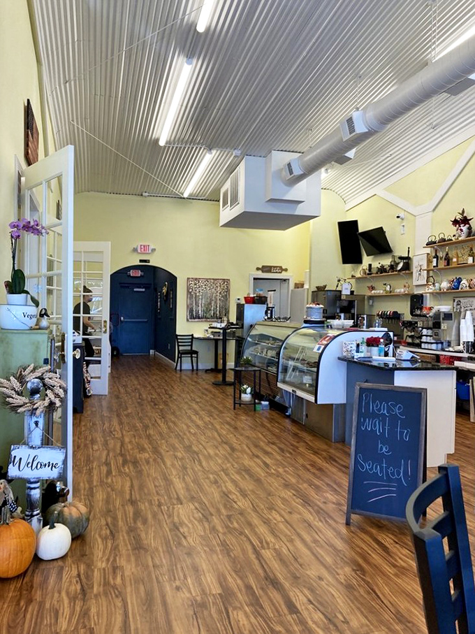 Inside, yellow walls and a corrugated metal ceiling create that perfect "grandma's kitchen got an upgrade" vibe. The handwritten "Please wait to be seated" sign tells you everything about their priorities.