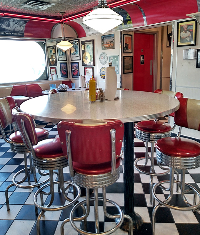 Red vinyl meets chrome in this quintessential diner interior. Those stools aren't just seats—they're front-row tickets to the breakfast show.